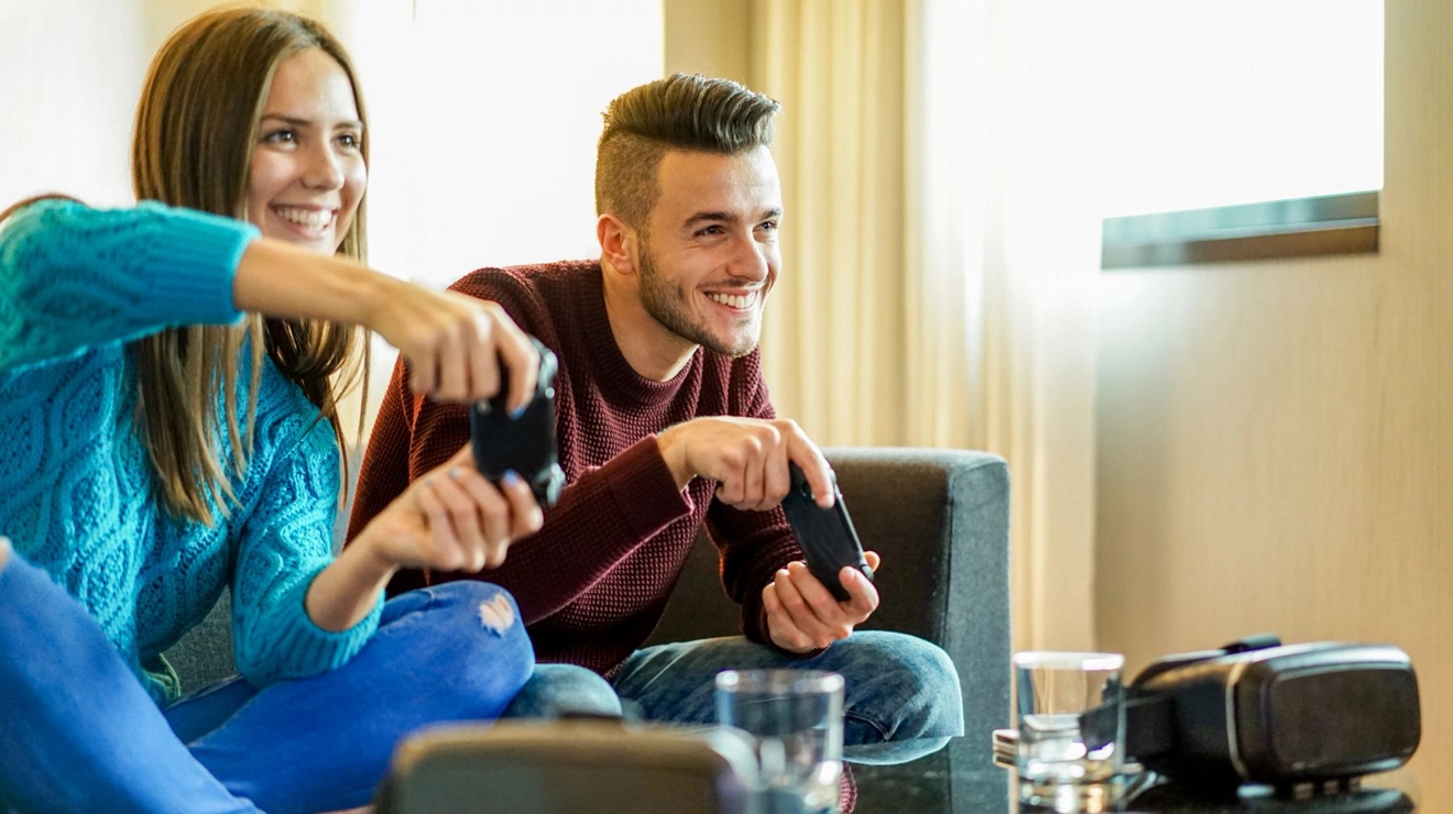 Two people on a sofa playing video game
